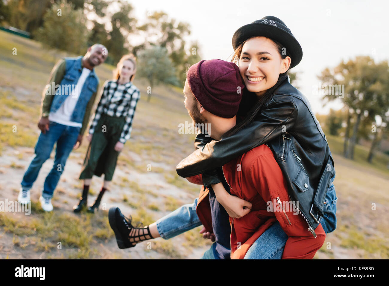 couple piggybacking in park Stock Photo - Alamy