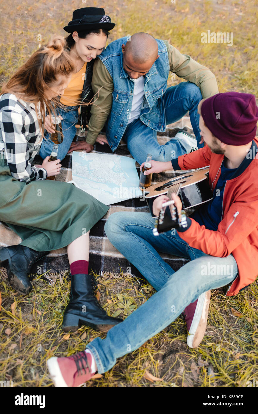multicultural friends with map in park Stock Photo - Alamy