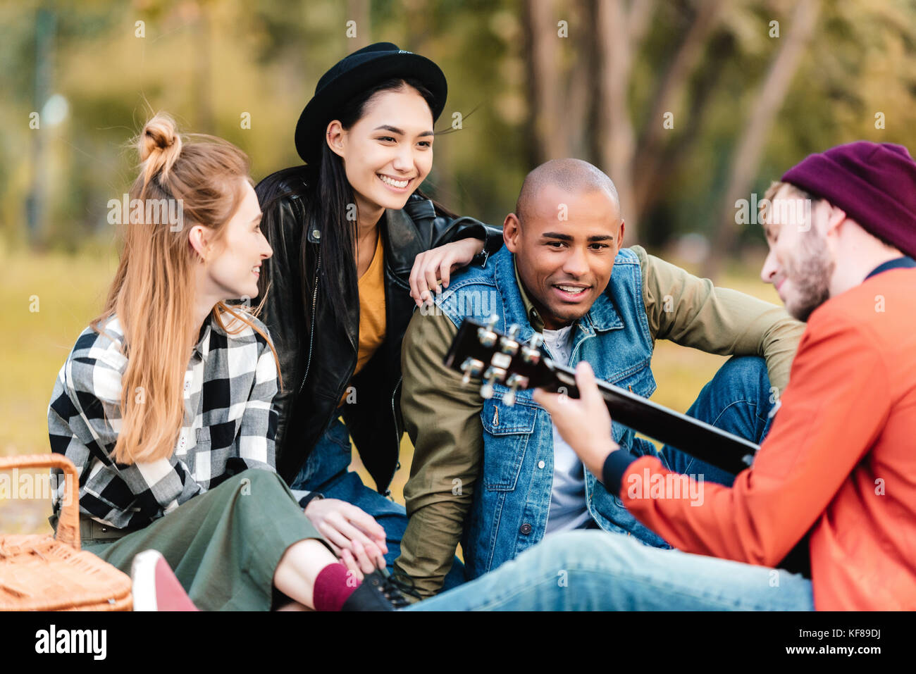 multicultural friends resting in park Stock Photo - Alamy