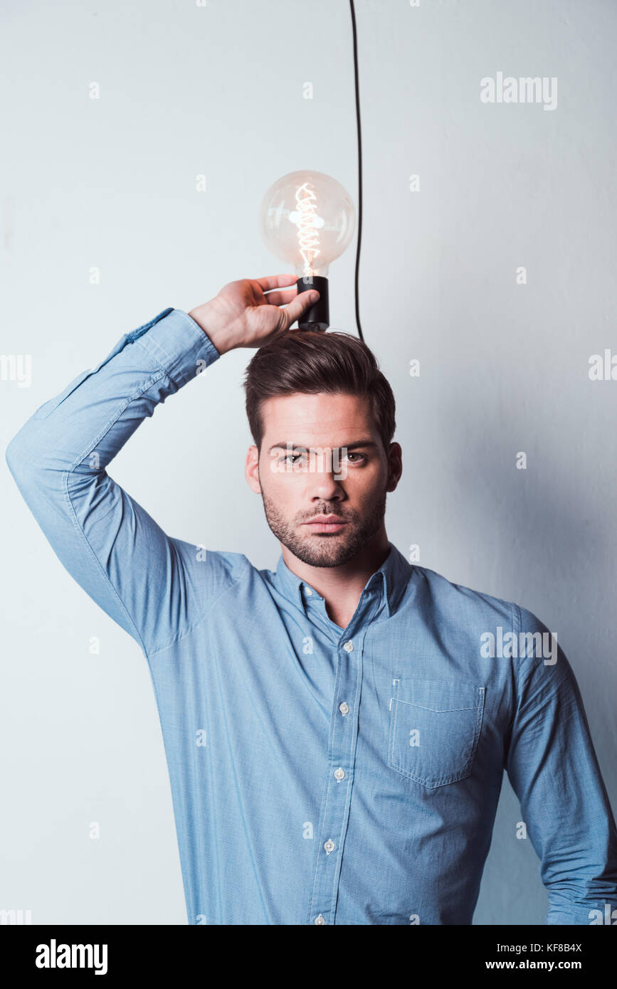 young businessman with light bulb Stock Photo - Alamy