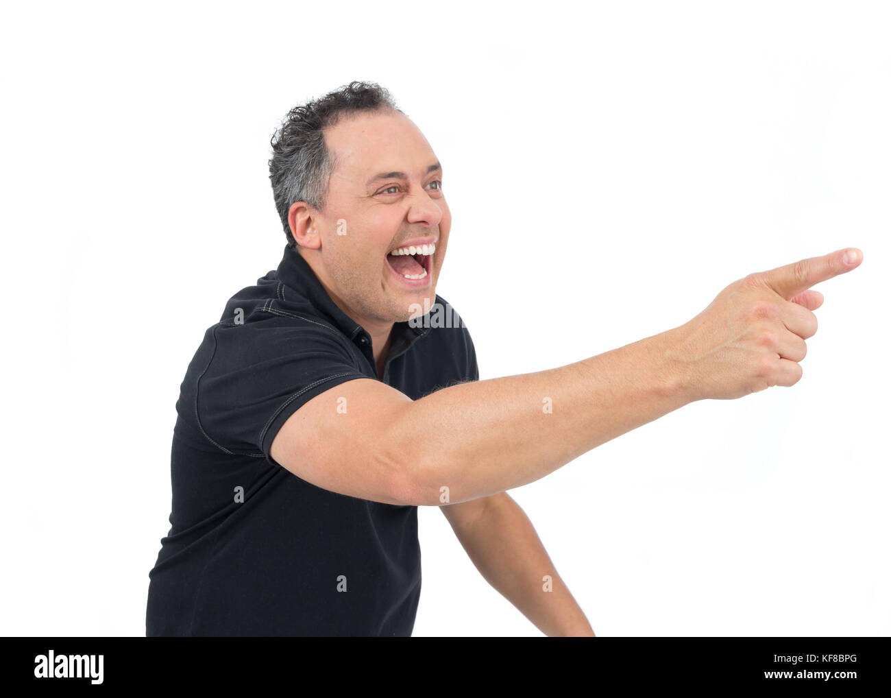 Man points forward and is laughing a lot. He is bald and is wearing a ...