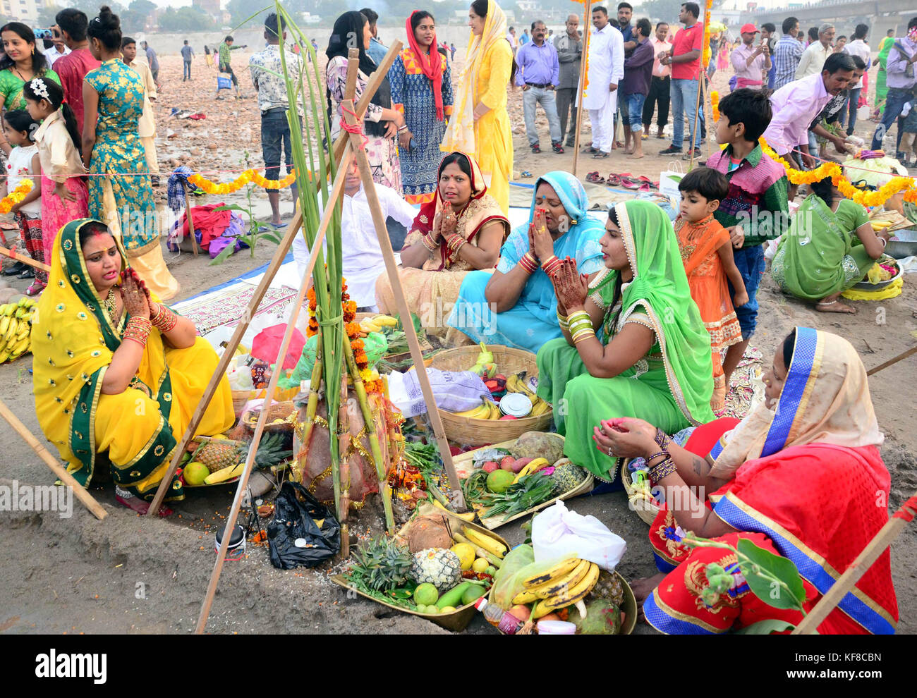 Jammu, India. 26th Oct, 2017. An Indian devotee receives a Tika, a red mark on her forehead, as ...