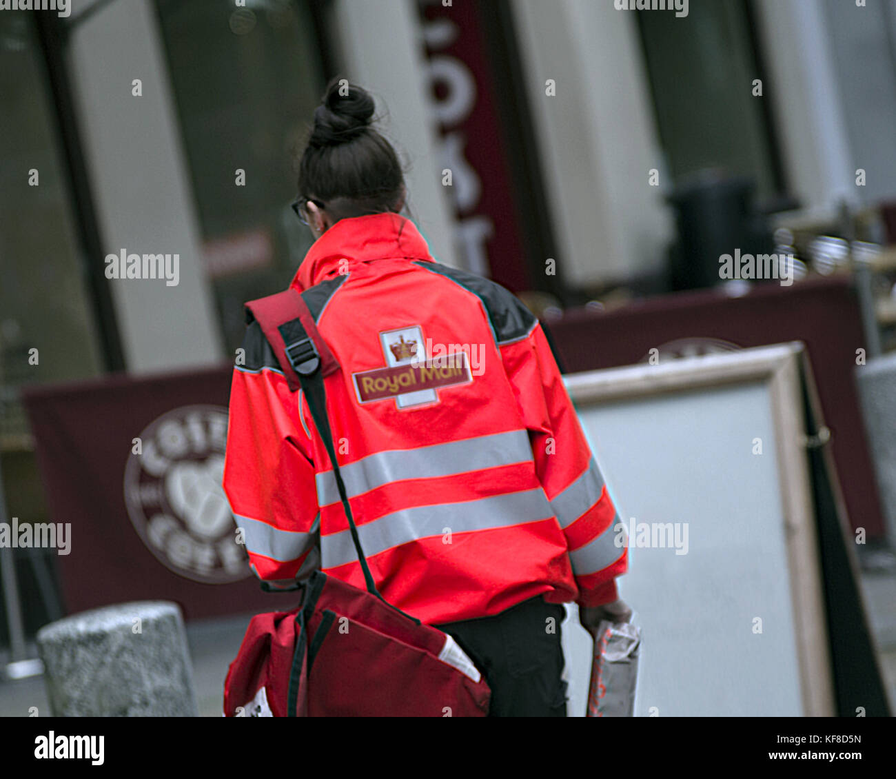 Royal Mail postman postwoman delivering letters street doorway costa ...