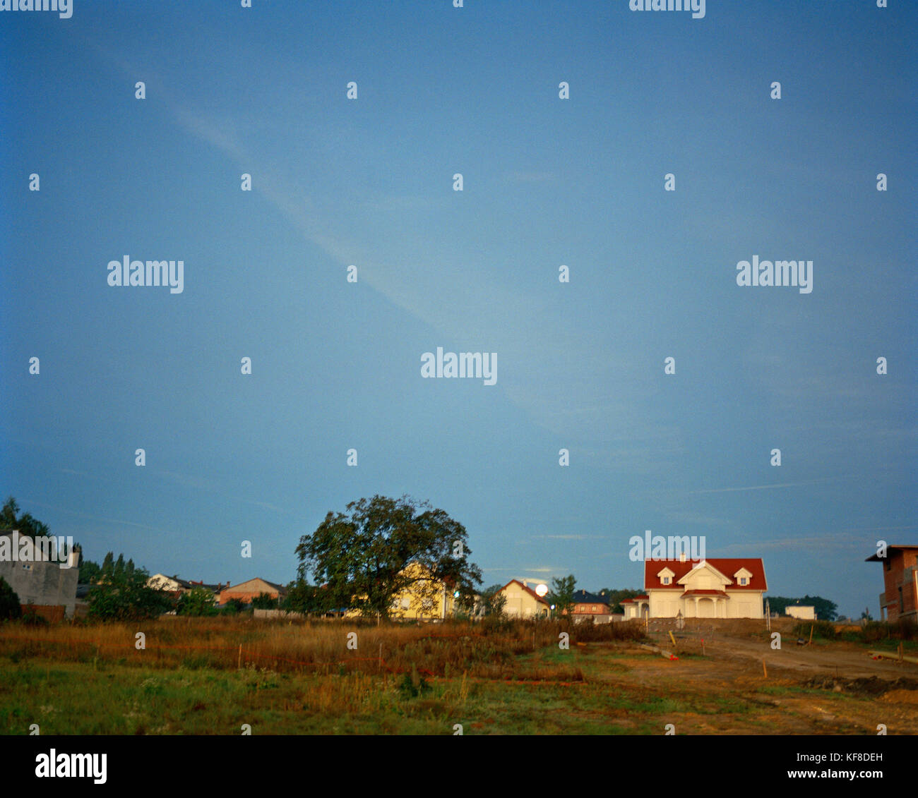 AUSTRIA, Morbisch, early morning sunrise with the full moon setting ...