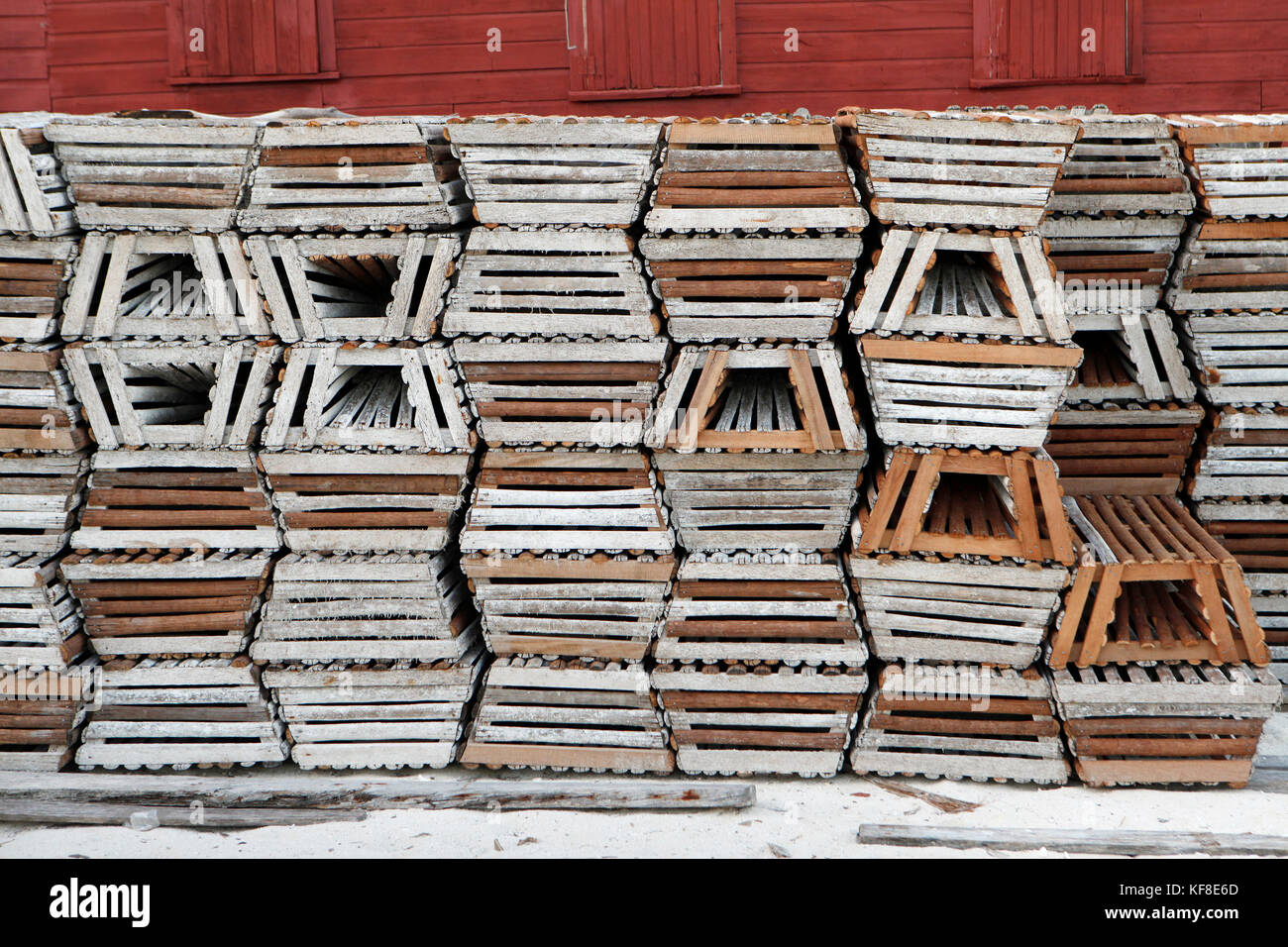 BELIZE, Caye Caulker, old traps are stacked by a boarded up building by ...
