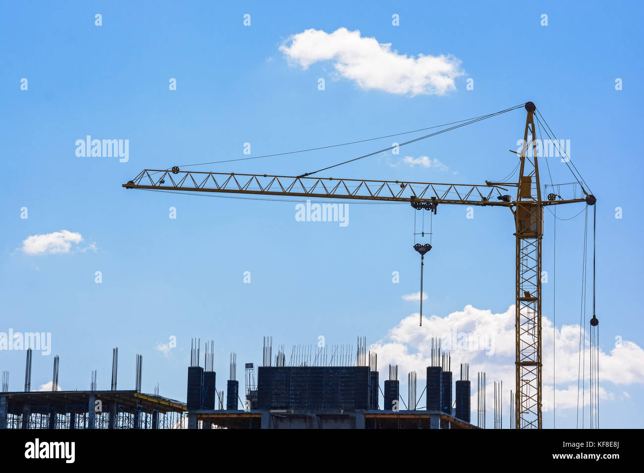 Construction crane builds new building Stock Photo - Alamy