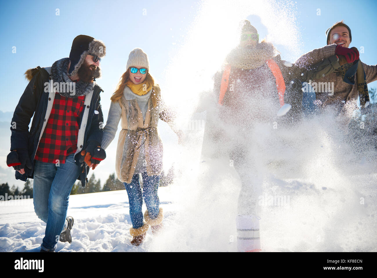 Having fun while kicking the snow Stock Photo - Alamy