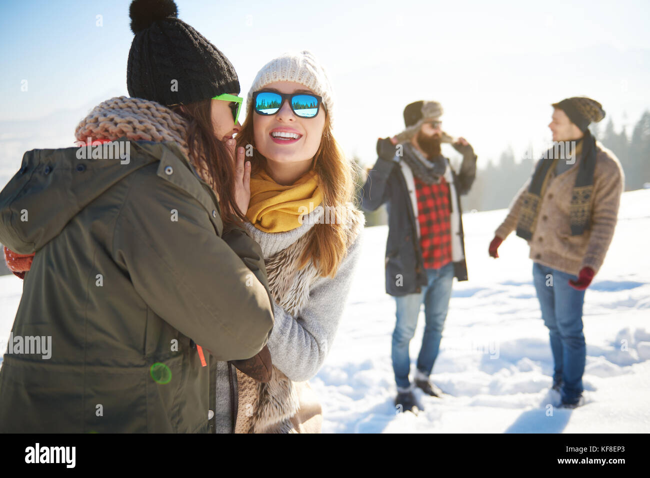 Woman whispering smiling friends hi-res stock photography and images ...
