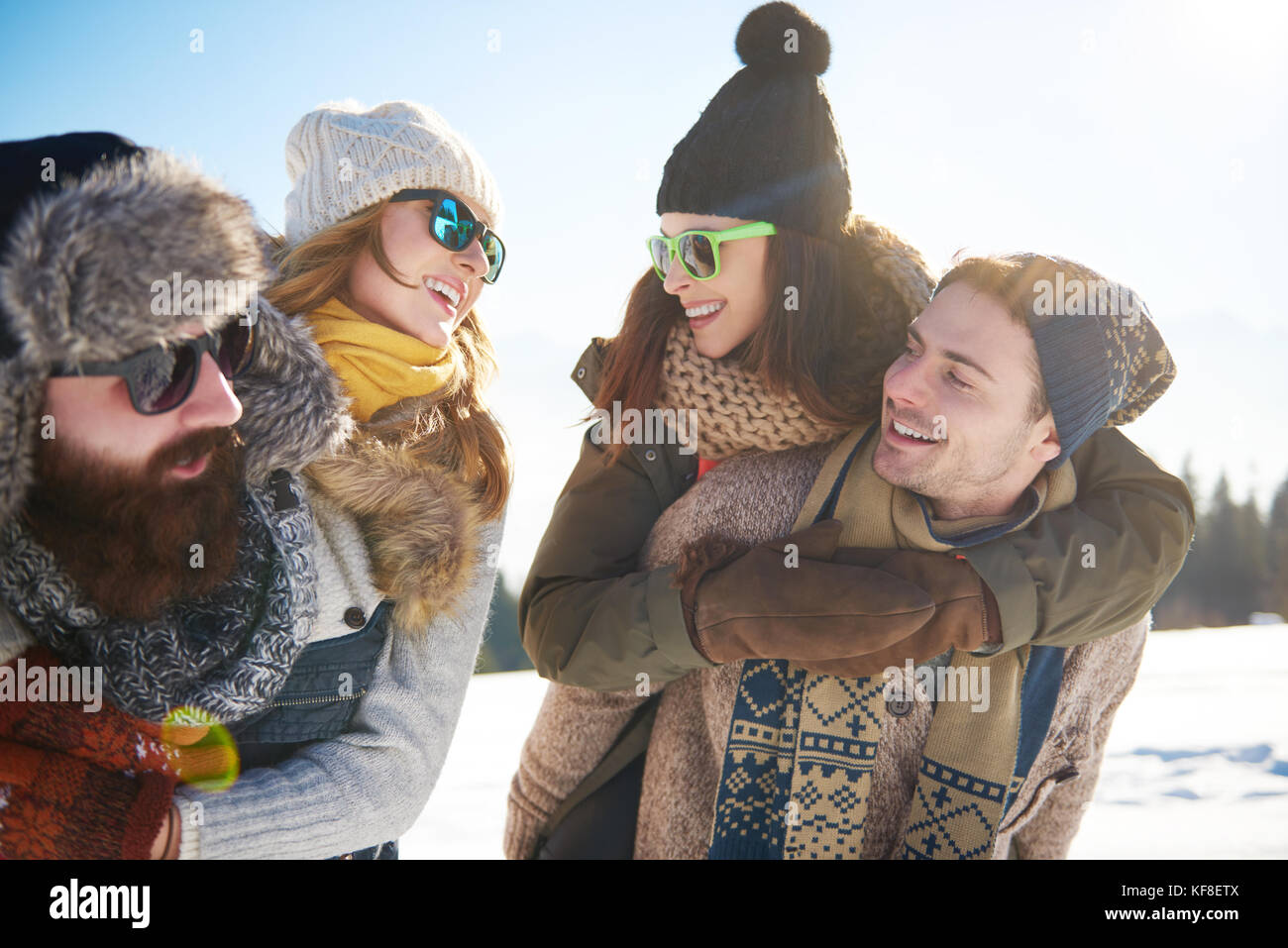 Guys piggyback girls on the mountains Stock Photo - Alamy