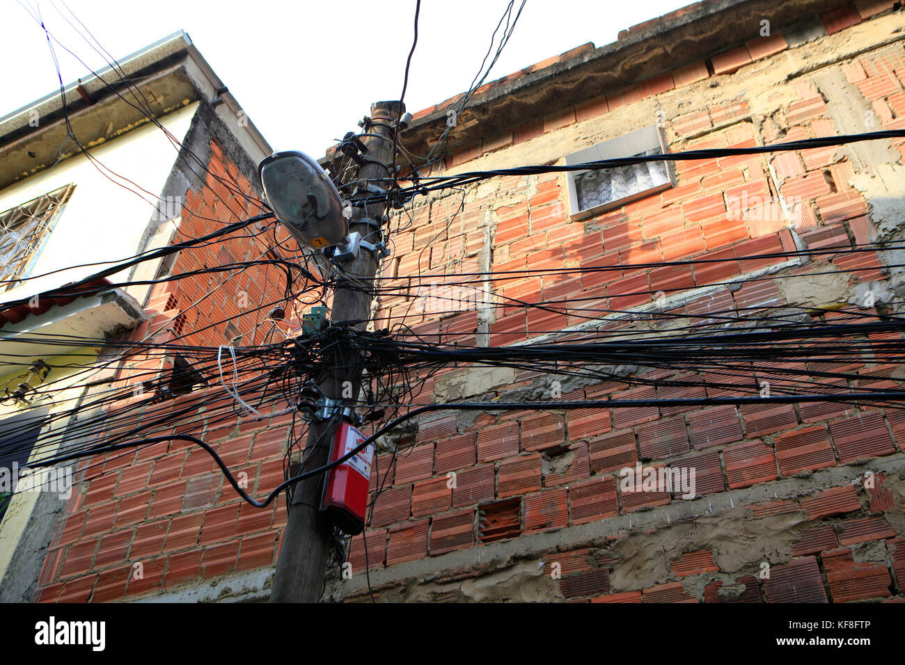 BRAZIL, Rio de Janiero, Favela, a mess of wires on a lamp post in ...