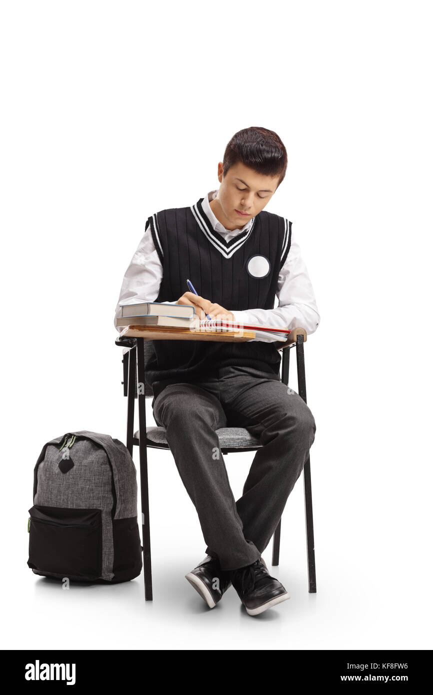 Teenage student sitting in a school chair and taking notes isolated on ...