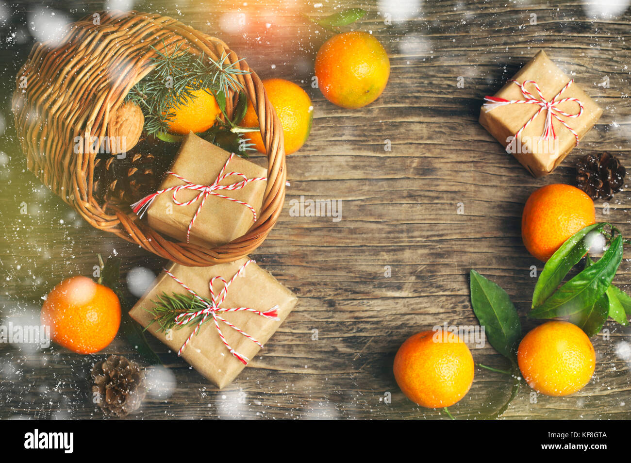 Festive Christmas Basket with gift boxes and tangerines, toned image ...