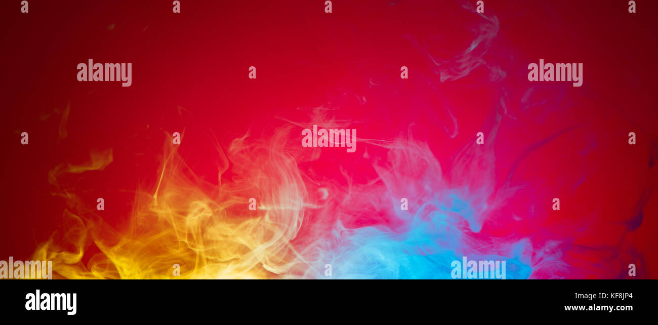 yellow and blue smoke on red background Stock Photo - Alamy