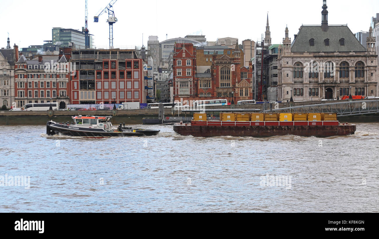 LONDON, UNITED KINGDOM - NOVEMBER 20, 2013: Barges Towed by a Tugboat ...