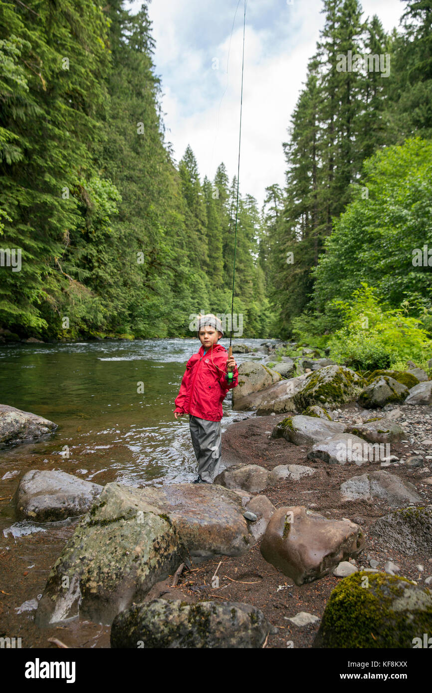 USA, Oregon, Santiam River, Brown Cannon, a young boy learning how to ...
