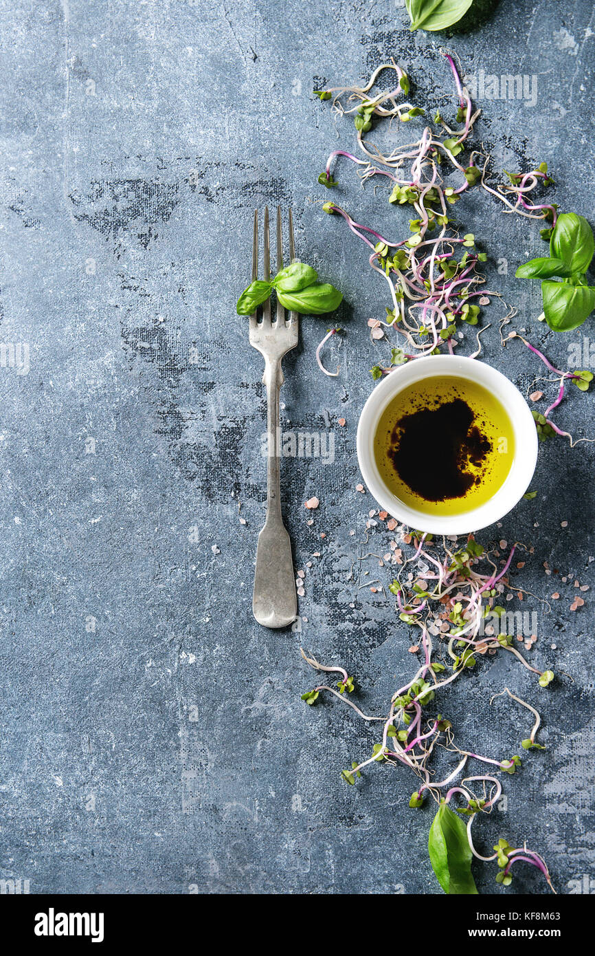 Young radish sprouts with pink himalayan salt and basil leaves with ...