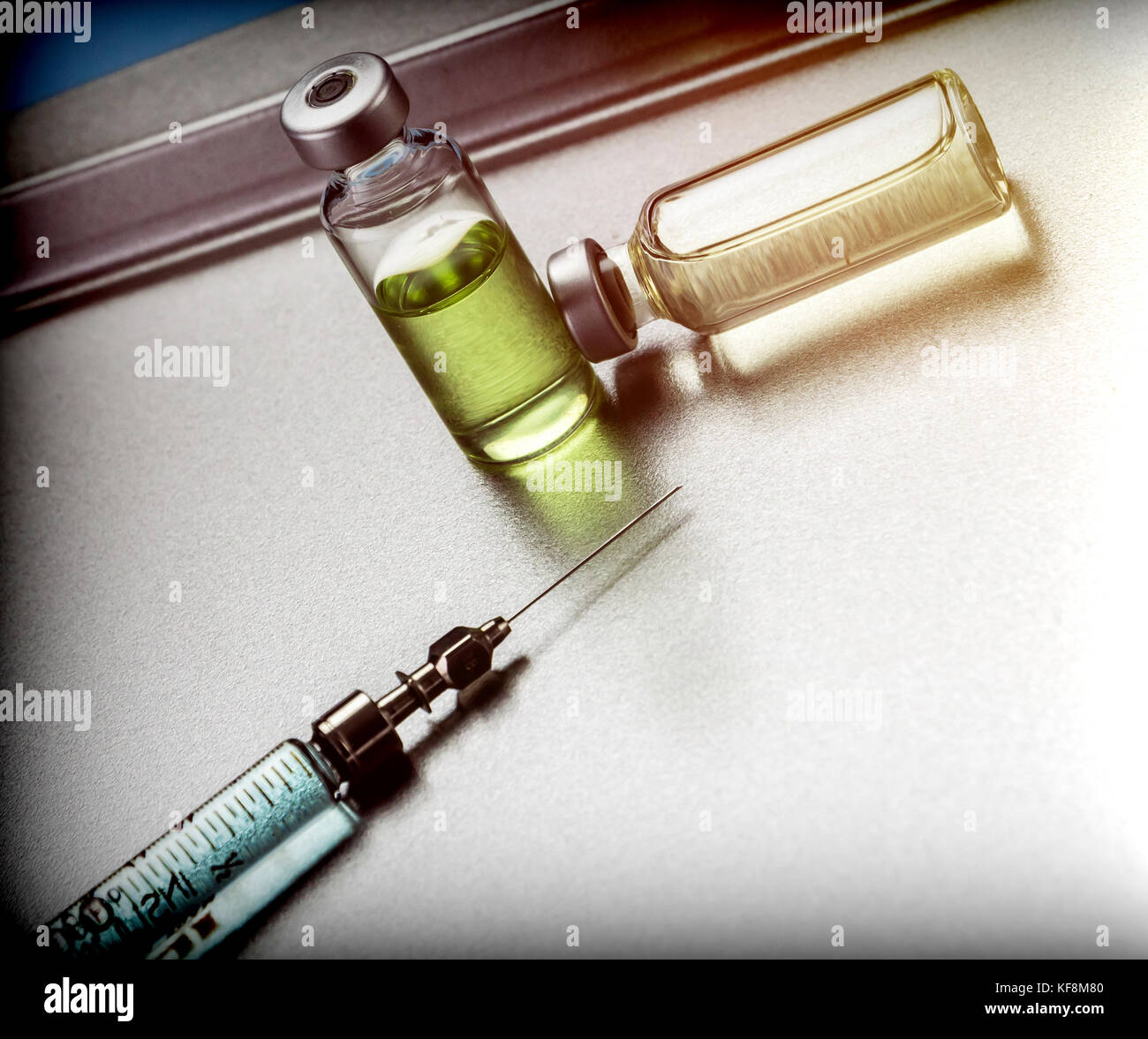 Several vials and syringe in laboratory, conceptual image Stock Photo - Alamy