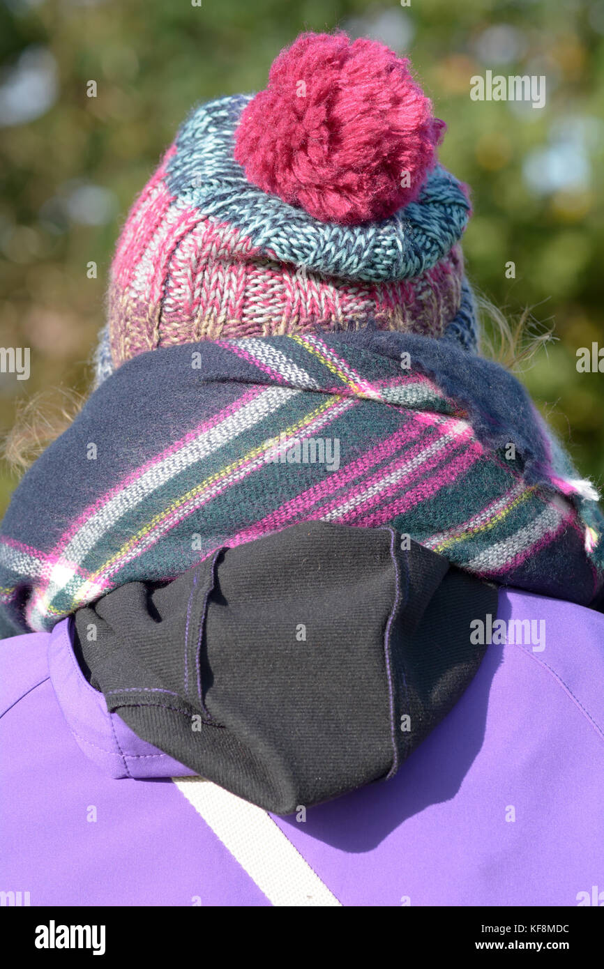 Woman wrapped up in warm winter clothing - coat, hat and scarf on cold ...