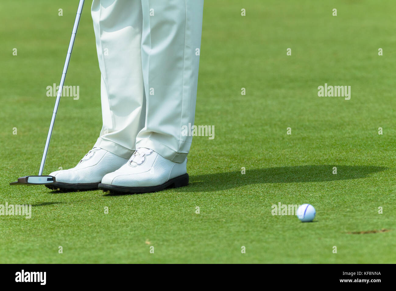 Golf player putting green closeup abstract shoes putter ball photo ...