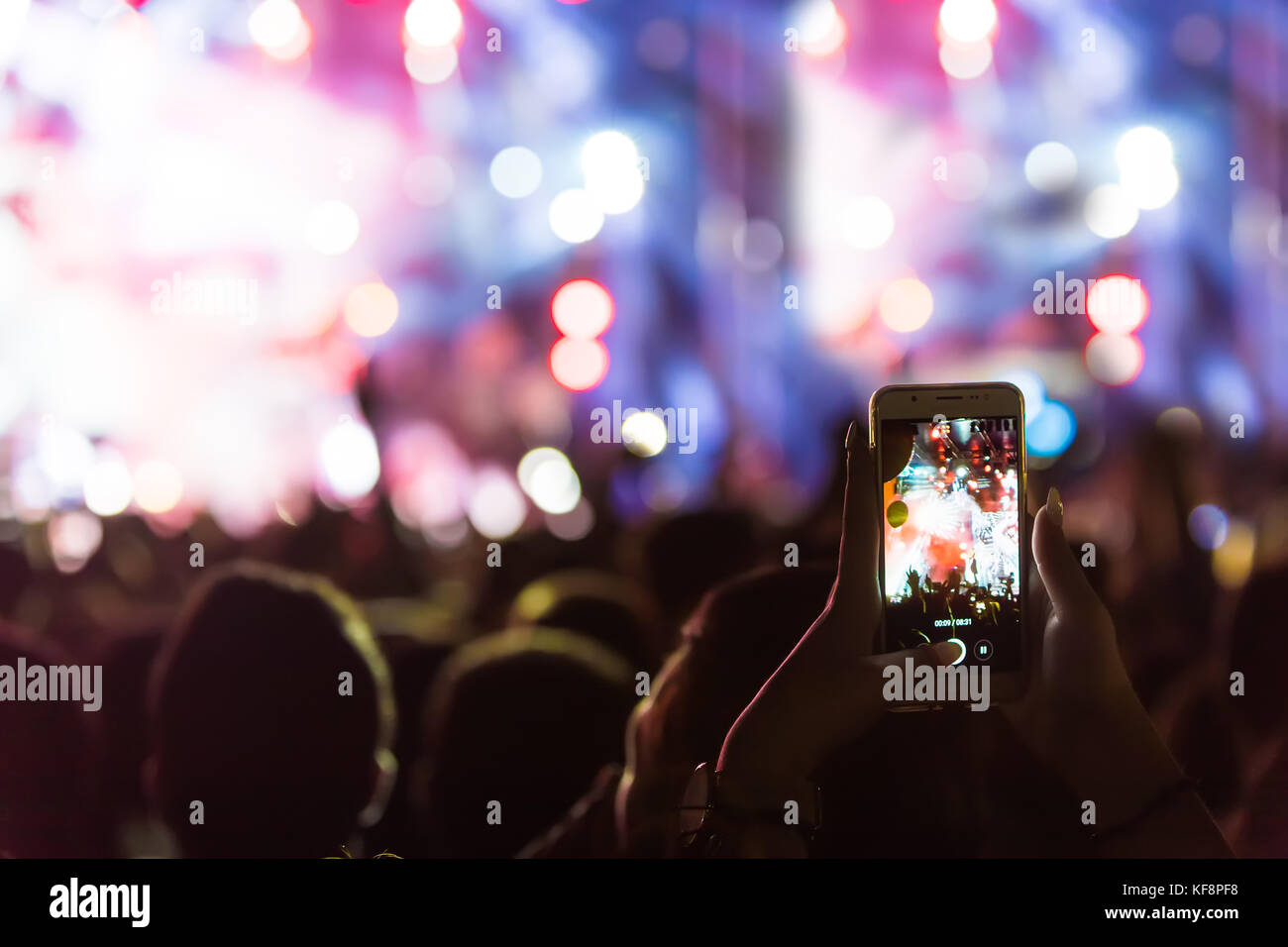 Hand with a smartphone records live music festival, Taking photo of ...