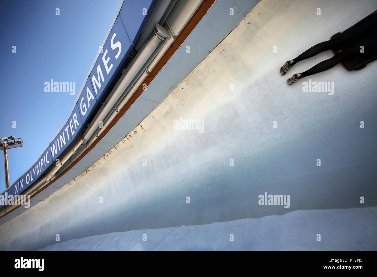 USA, Utah, Park City, a skeleton races high around turn 12 at Utah ...