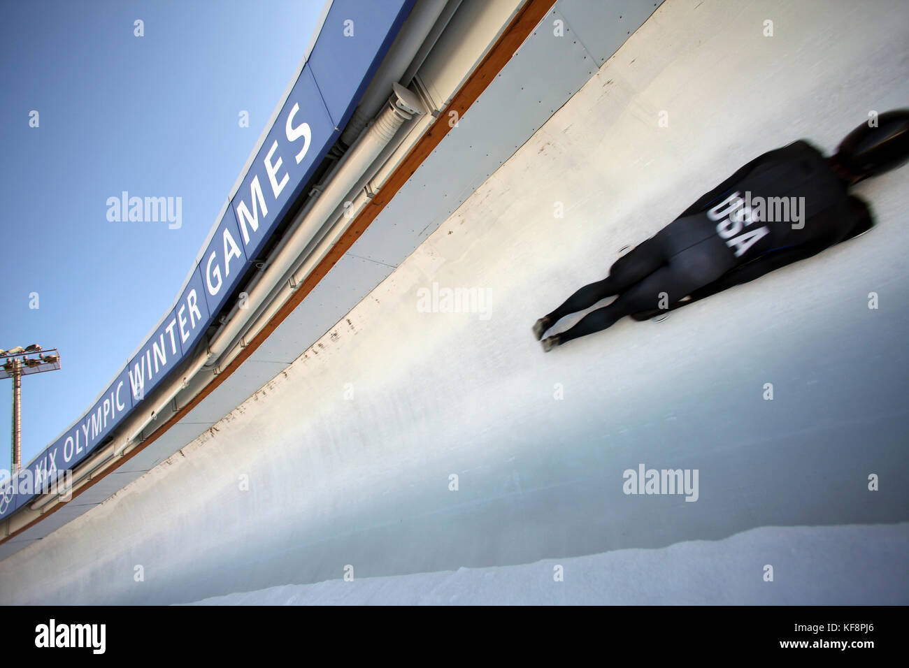 USA, Utah, Park City, a skeleton races high around turn 12 at Utah ...