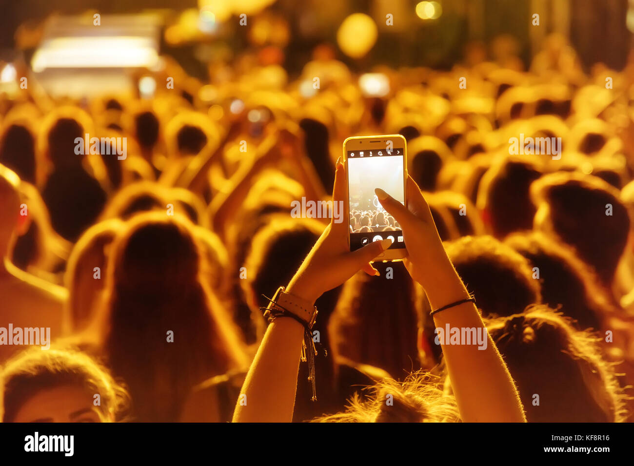 Hand with a smartphone records live music festival, Taking photo of ...