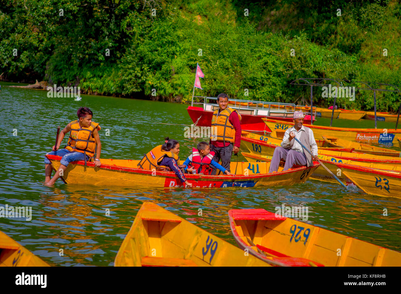 POKHARA, NEPAL - NOVEMBER 04, 2017: Family paddling the boats in the ...