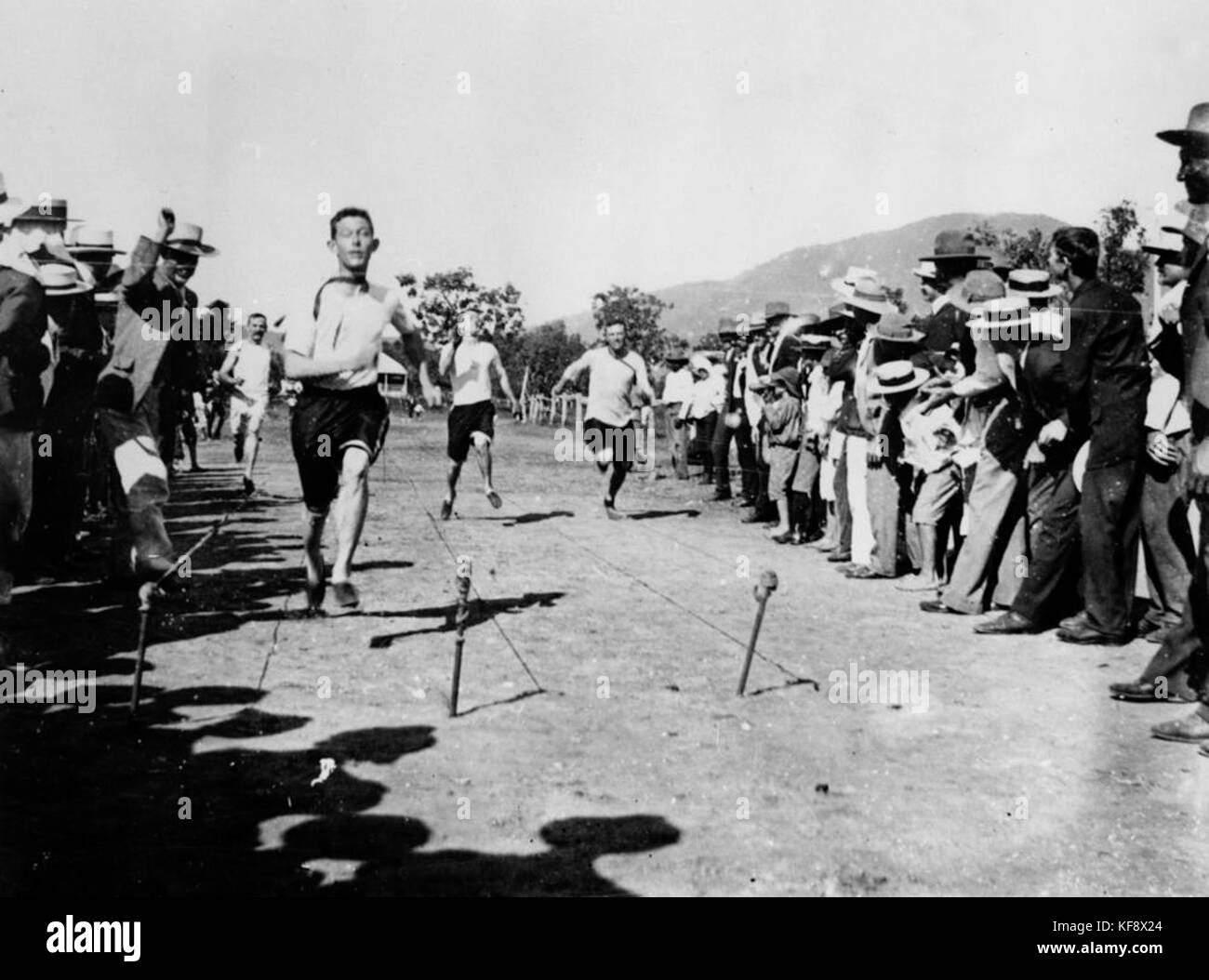 This historical photograph from around 1907 shows sprinters approaching ...