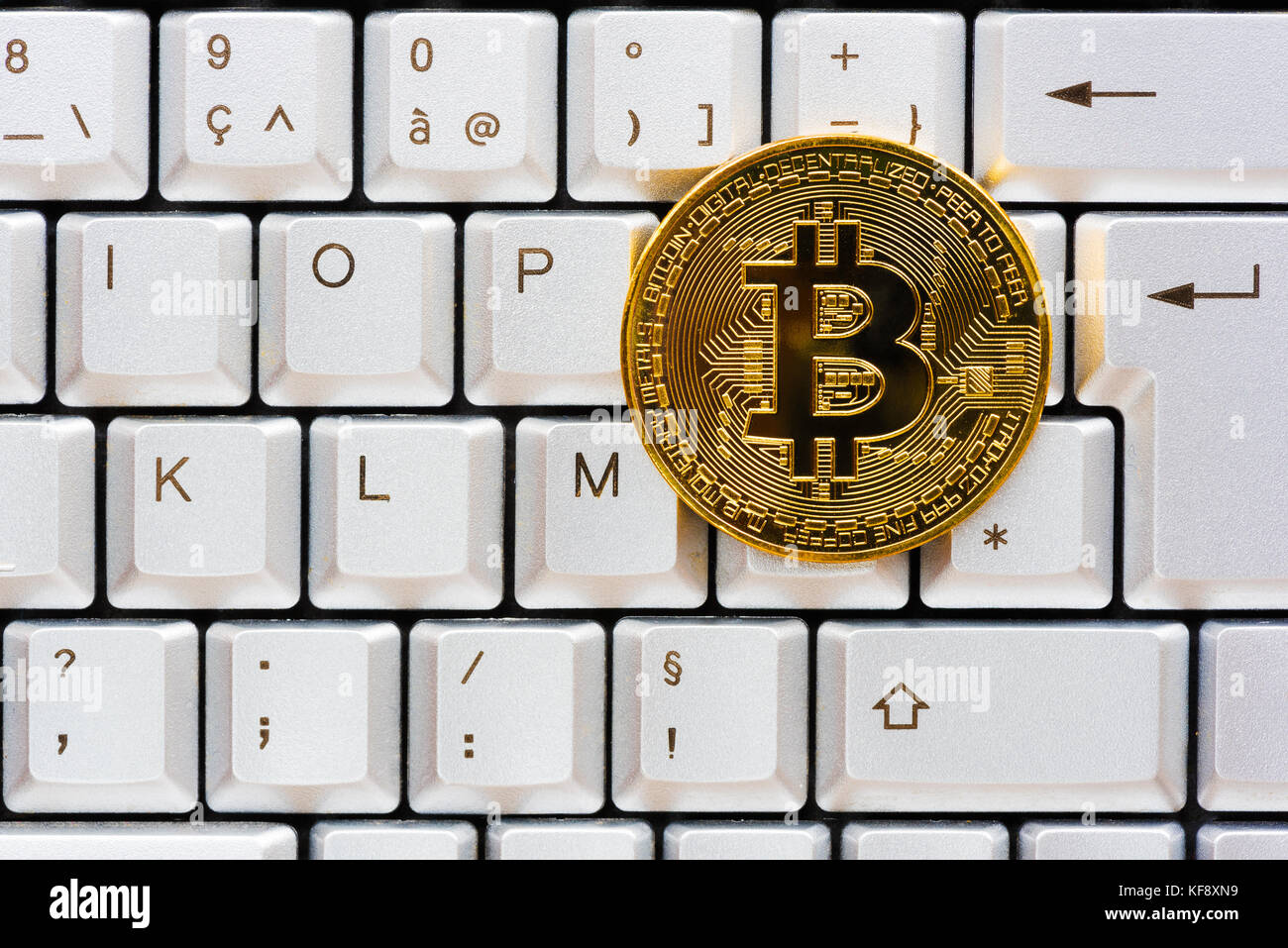 Golden color bitcoin on a computer keyboard Stock Photo - Alamy