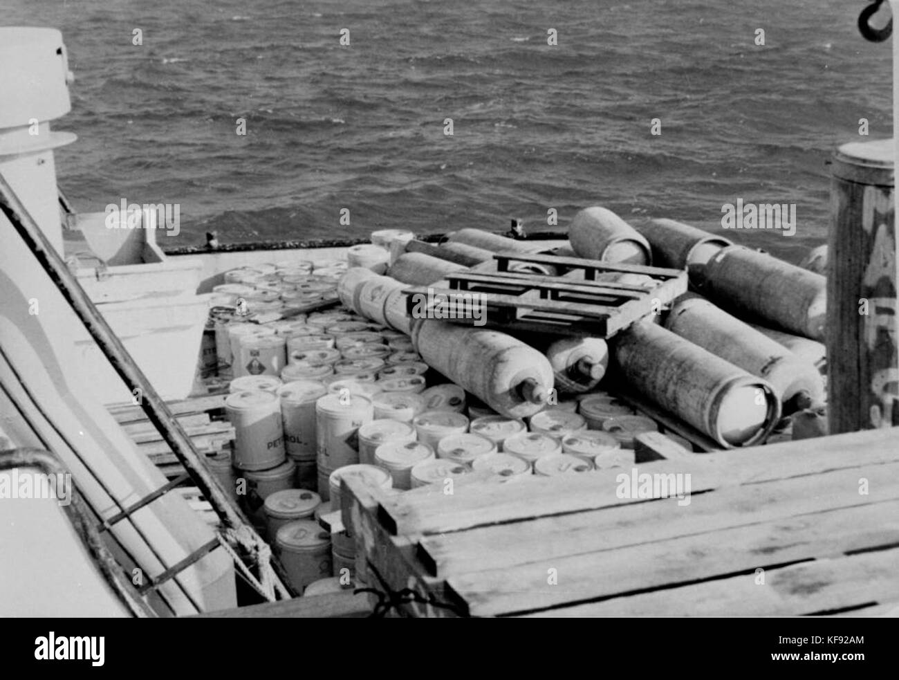 This photograph shows fuel drums and cargo loaded onto the deck of the ...