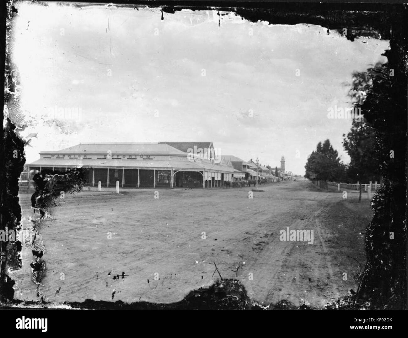 This historical photograph shows the Warwick Emporium and the shops ...