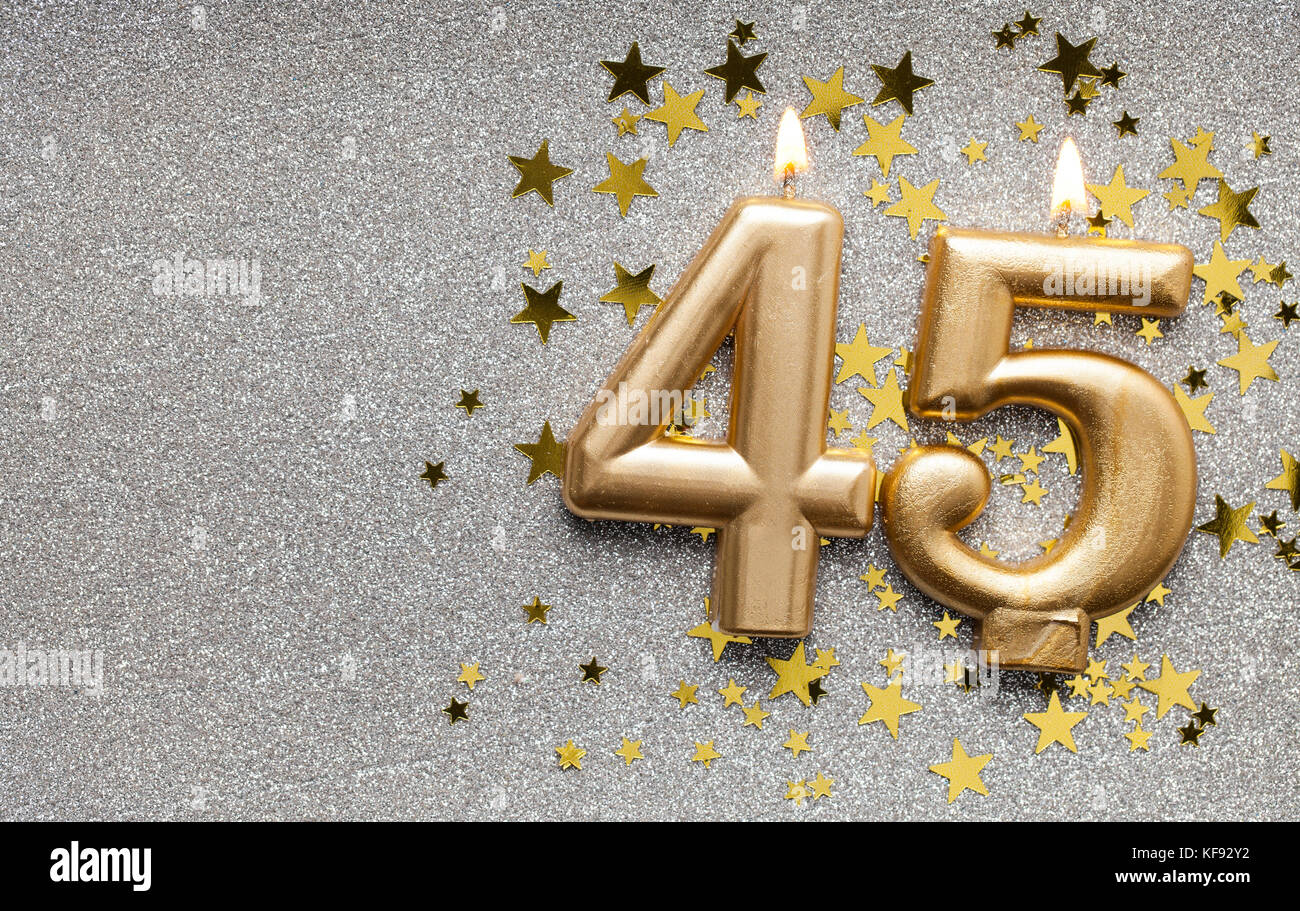 Number 45 gold celebration candle on star and glitter background Stock ...