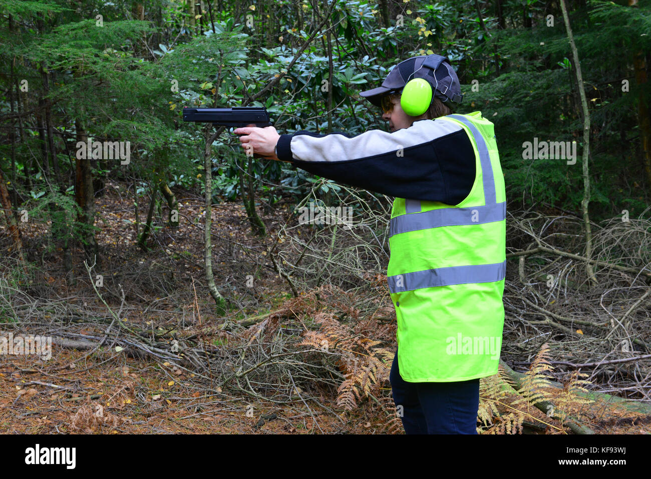 A Lady wearing PPE at a shooting range in the UK Stock Photo - Alamy