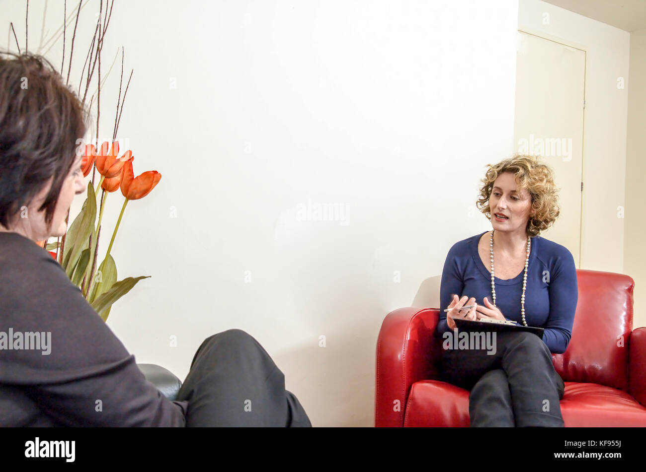 A female therapist during a one on one session with a client seeking ...