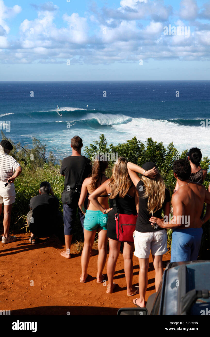 USA, Hawaii, Maui, spectators watch windsurfers on large waves at a ...