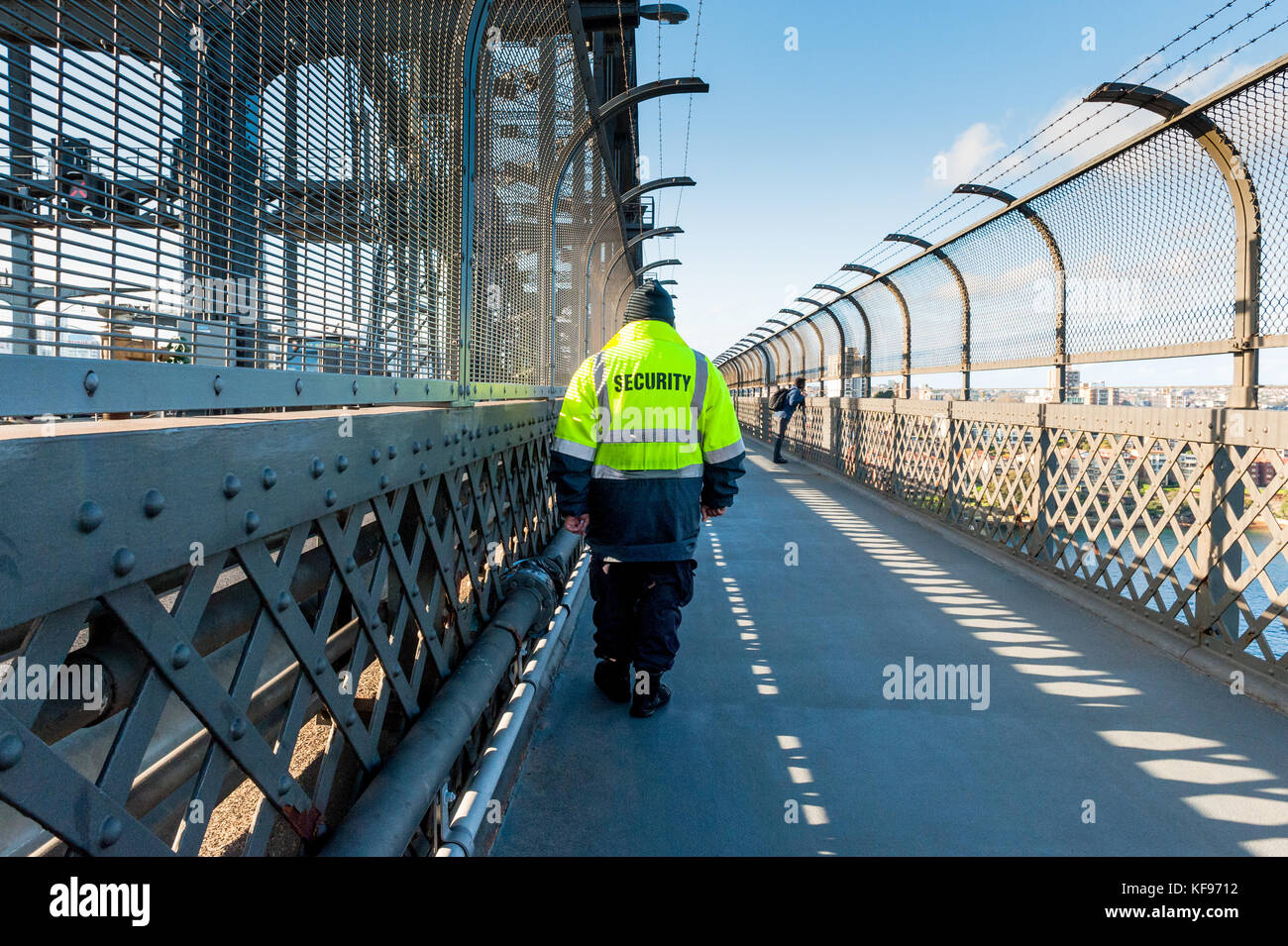 A security guard patrols the path along the famous Sydney Harbour ...