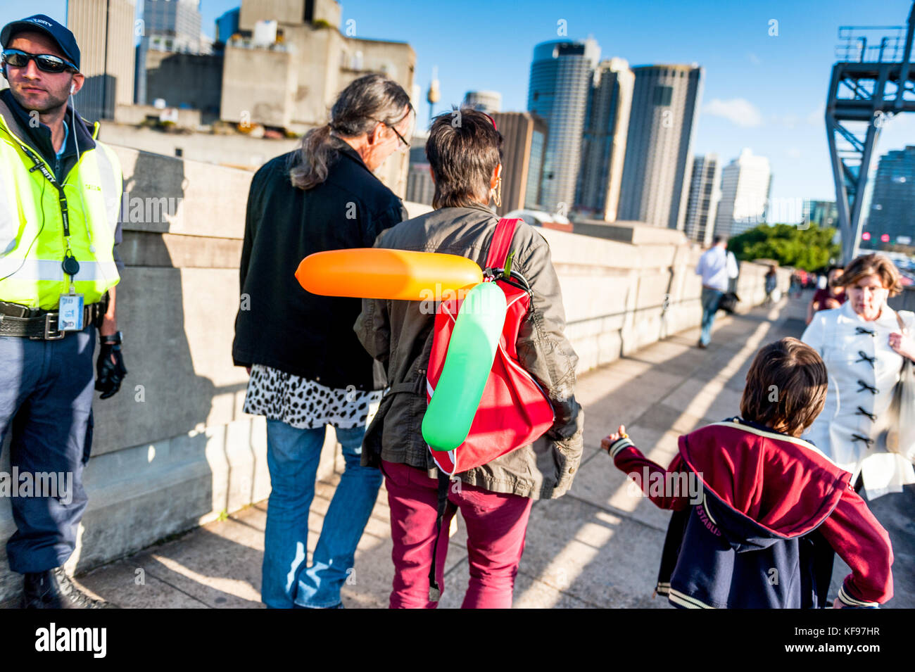 A family walk along the path of Sydney Harbour Bridge in Sydney ...