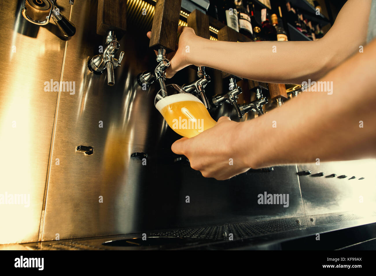 Hand of bartender pouring a large lager beer in tap Stock Photo - Alamy
