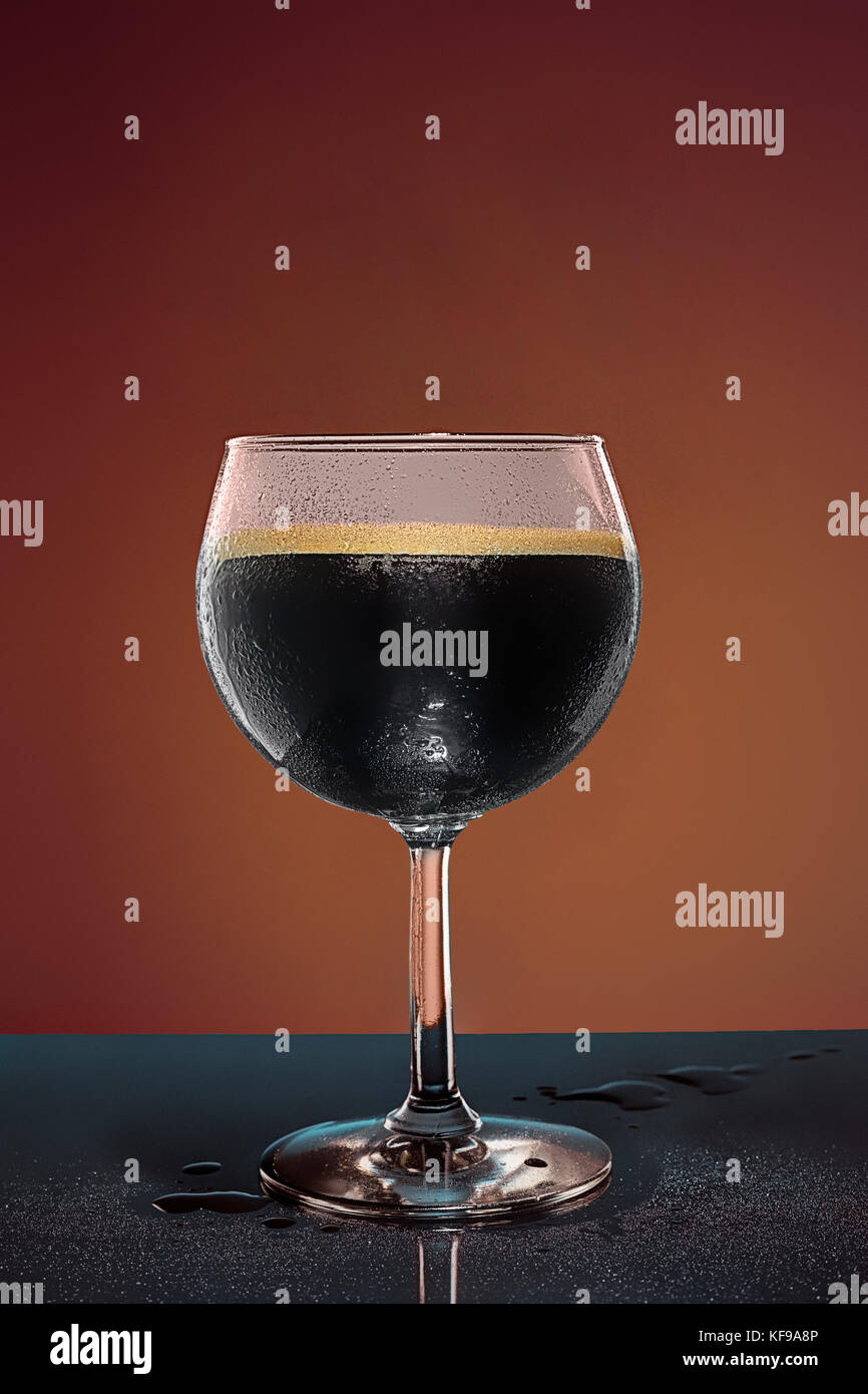 glass of cold frothy dark beer on an old wooden table Stock Photo - Alamy