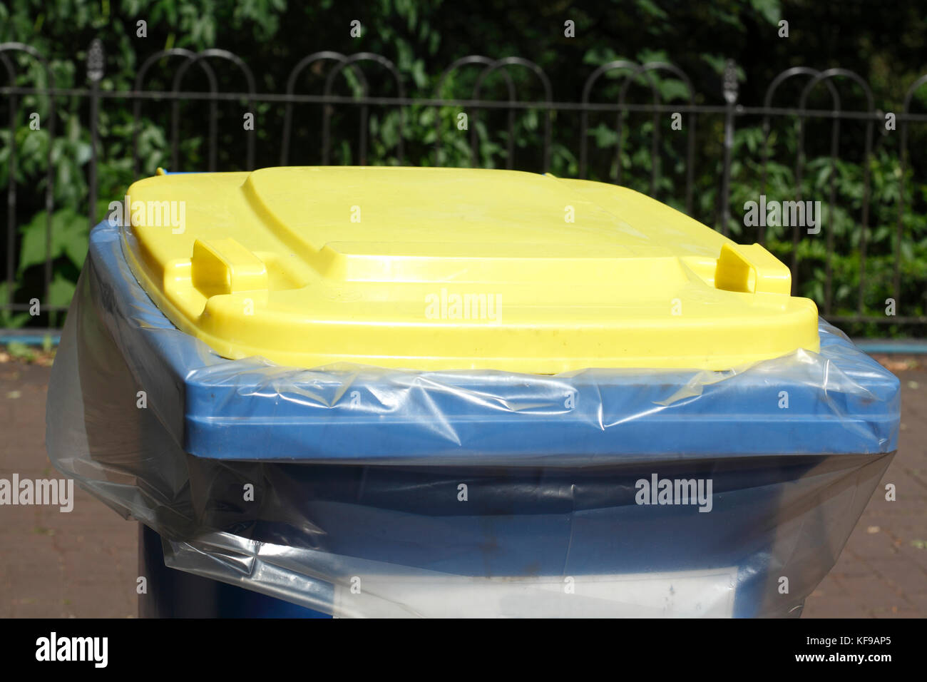 yellow public garbace can, waste bin Stock Photo - Alamy