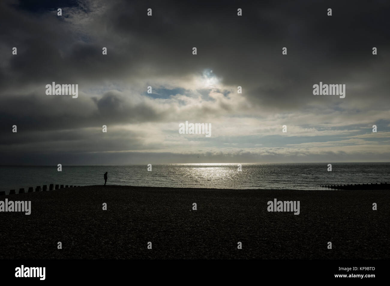 Lone individual on Eastbourne beach, UK Stock Photo - Alamy