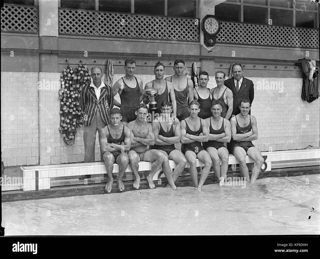 This historic photograph shows a large group of male swimmers at the ...