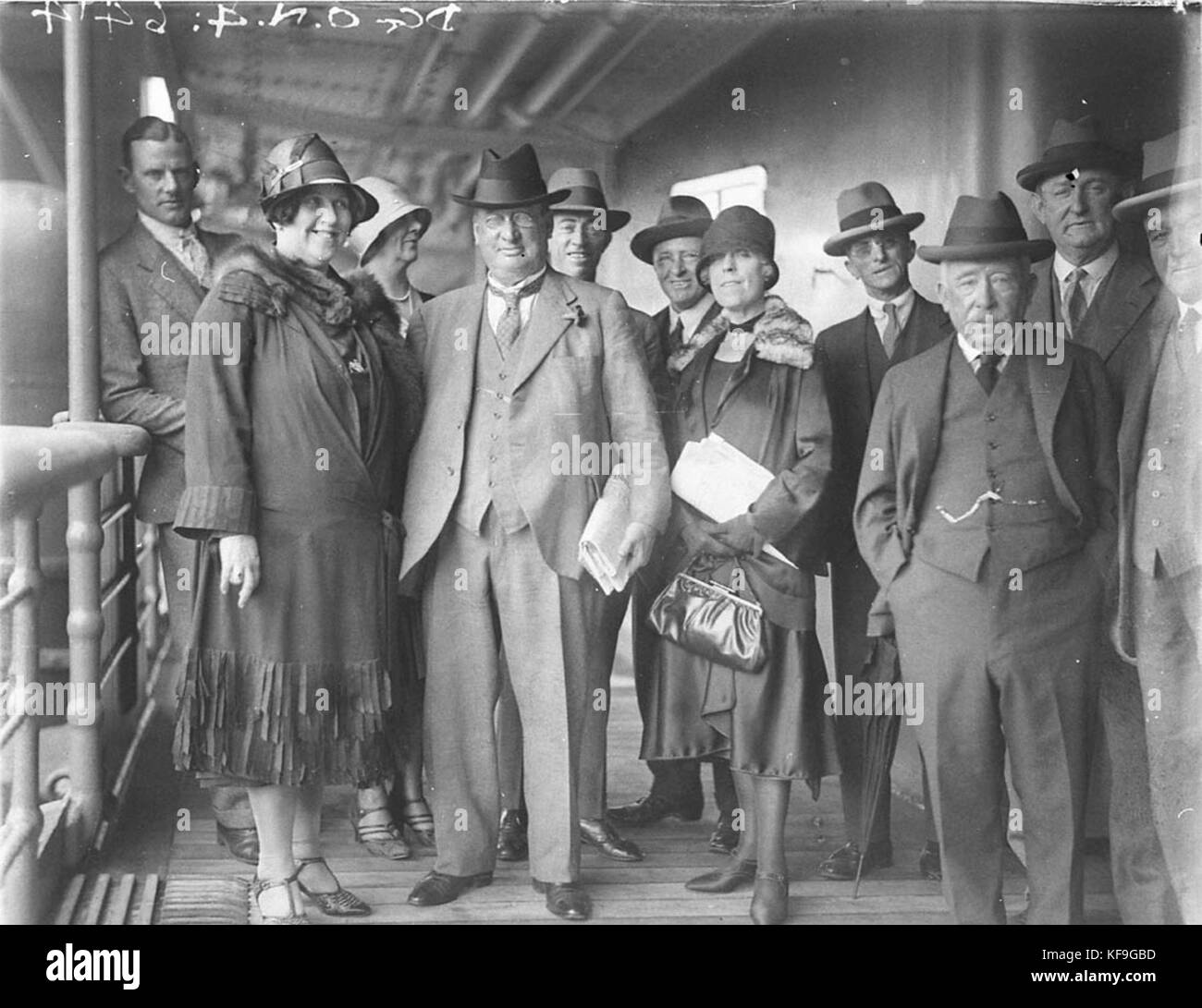 This image depicts a group of passengers, possibly from a historical or ...
