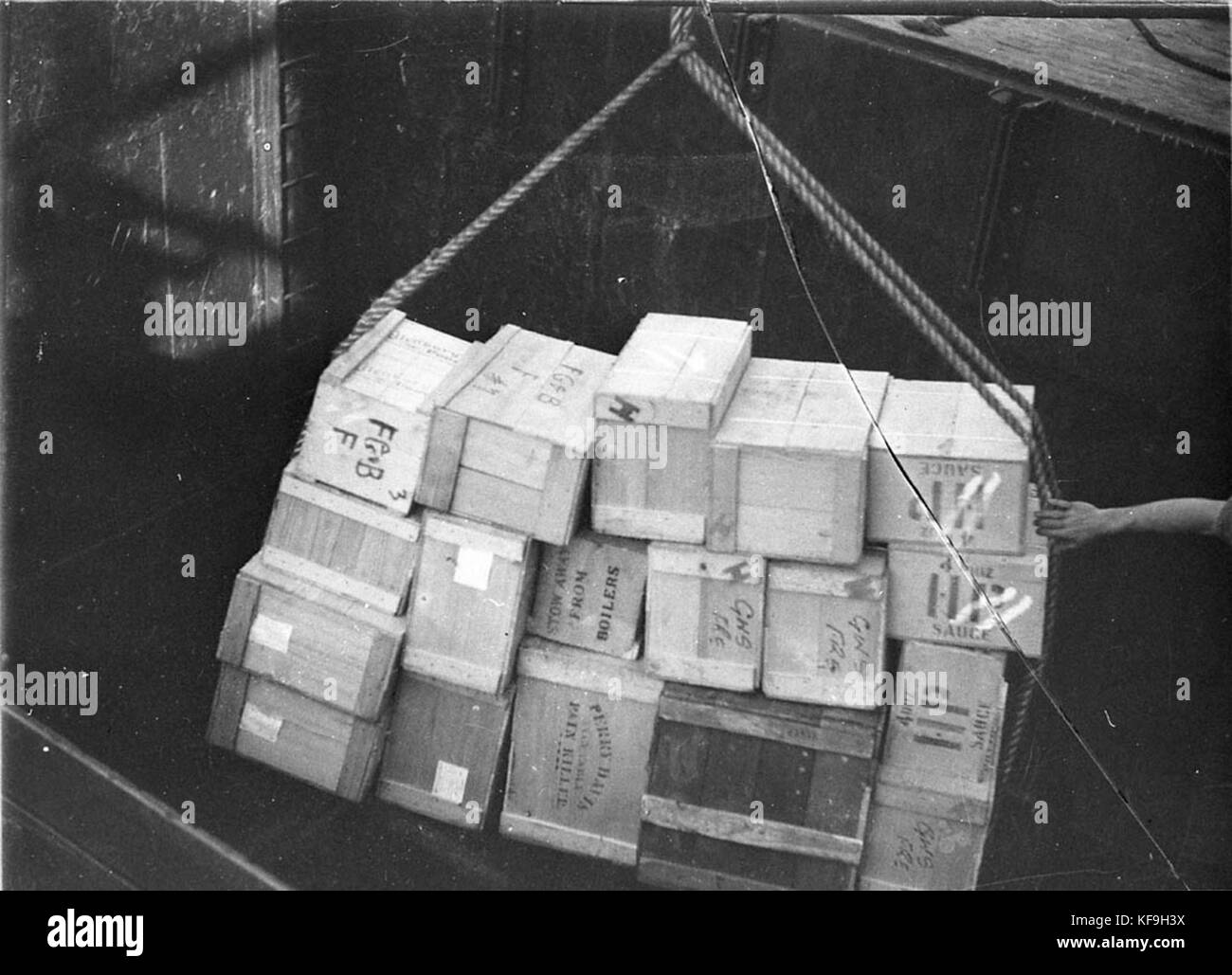 442585 Loading wooden boxes into the hold of a ship Stock Photo - Alamy