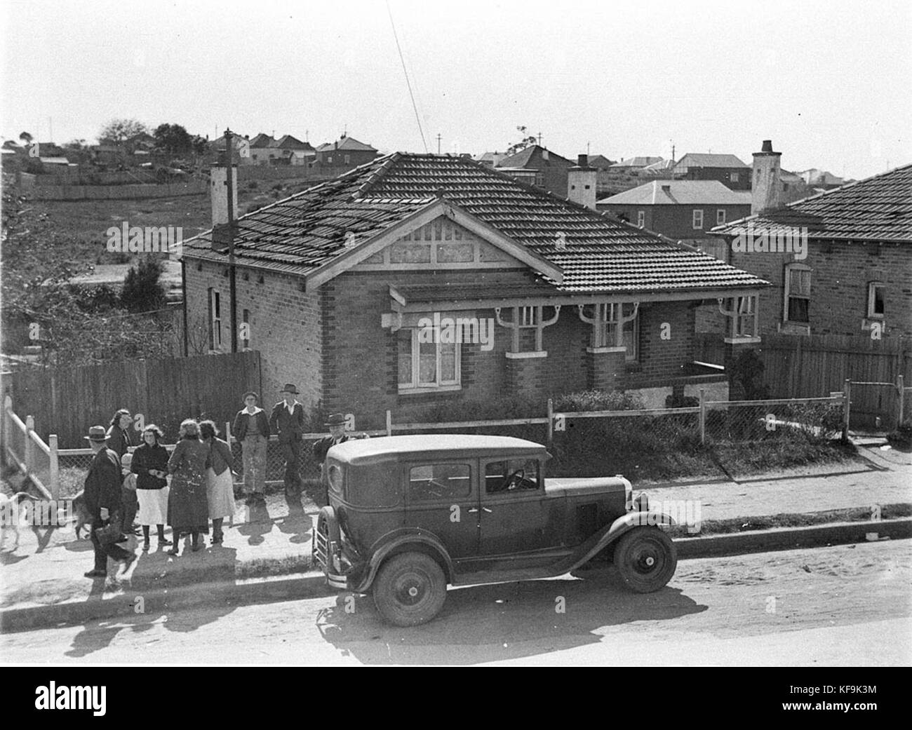 A photograph showing damage to houses caused by a storm, depicting the ...