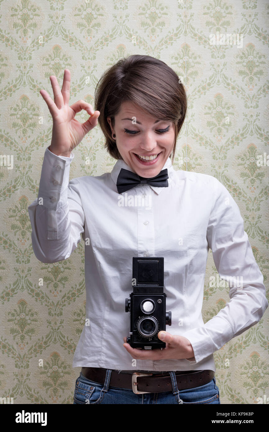 vintage photographer showing an OK sign in front of a vintage ...
