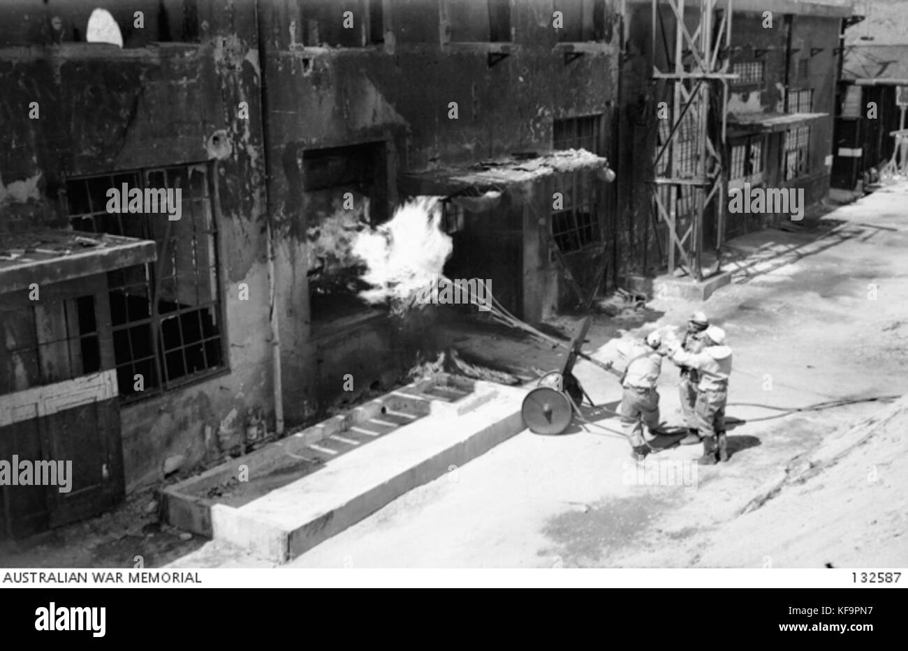 132587 JAPANESE WORKMEN WEARING GAS MASKS DIRECTED JETS FROM A MOBILE ...