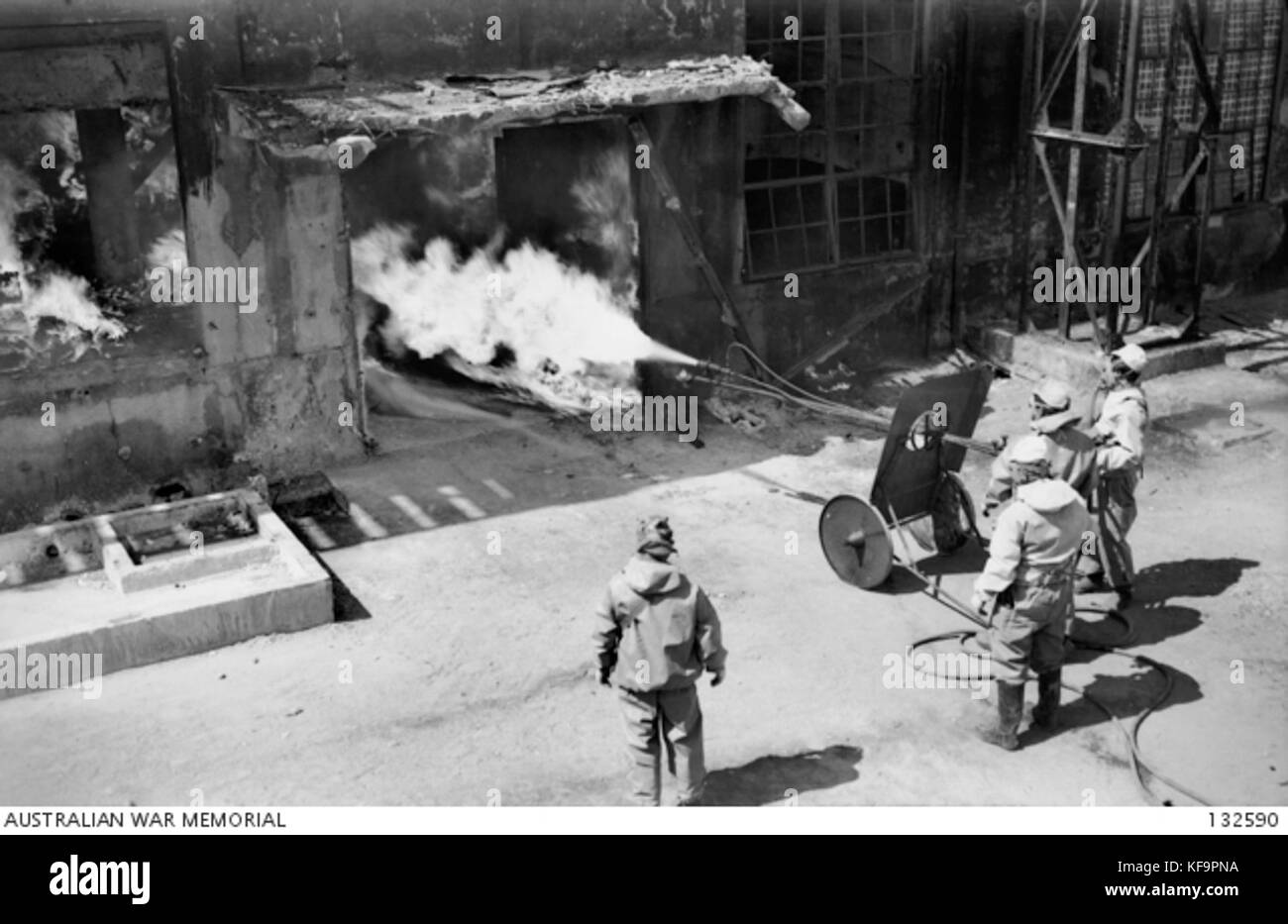 132590 JAPANESE WORKMEN WEARING GAS MASKS DIRECTED JETS FROM A MOBILE ...