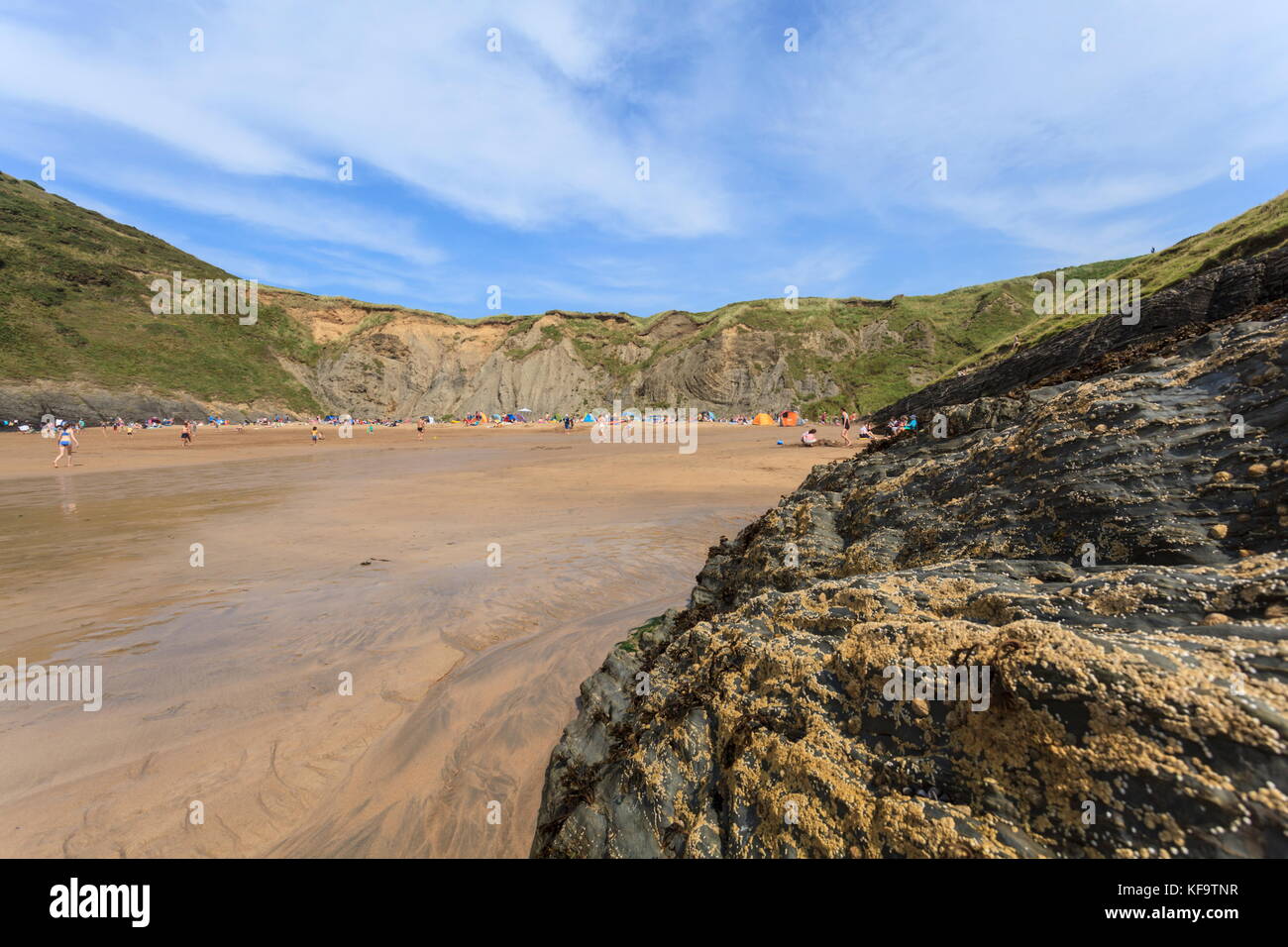 A view looking up Mwnt beach from the low tide mark on a summers day ...